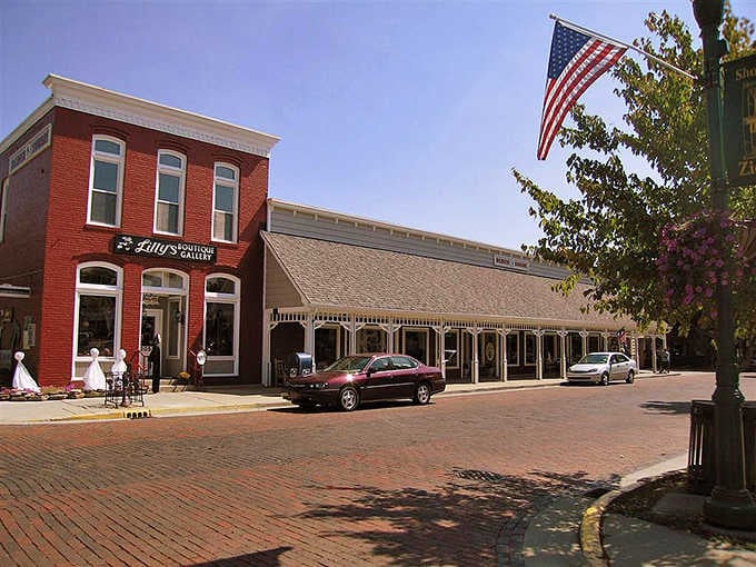 Those brick streets and red storefronts create a Main Street USA vibe that Walt Disney would've absolutely loved.