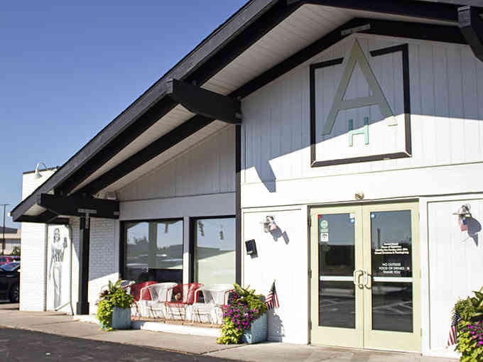 Clean lines and bright white siding create a welcoming modern farmhouse vibe that says "come on in, friend."