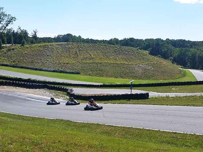 Three racers carve through curves with mountain views that make every lap feel like a scenic adventure.