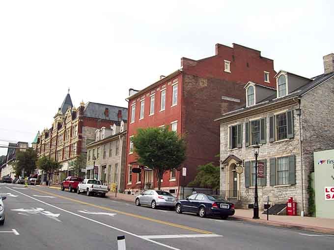 Historic brick facades and stone architecture create a streetscape that feels like stepping into a gentler, more gracious era.