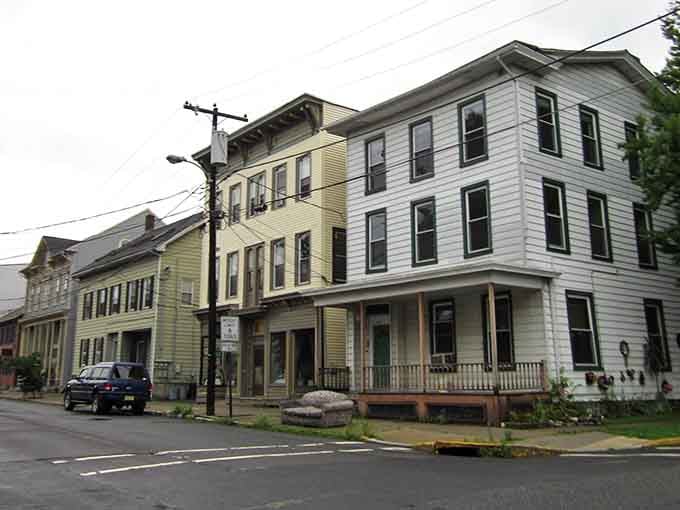 These historic buildings wear their age beautifully, painted in soft hues that whisper tales of simpler times.