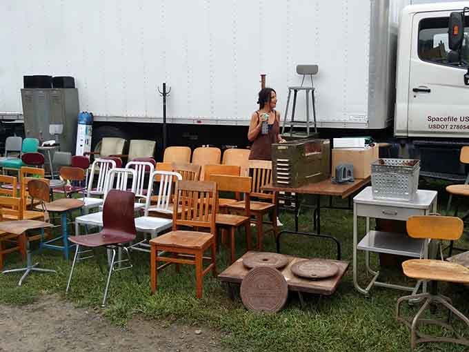 Vintage chairs lined up on the lawn waiting for new homes, each one with stories to tell.