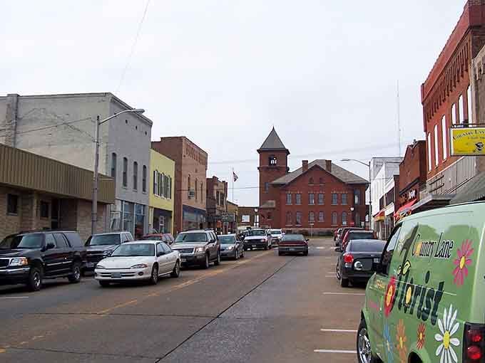 Main Street stretches toward history, where every storefront whispers stories your smartphone could never tell you.