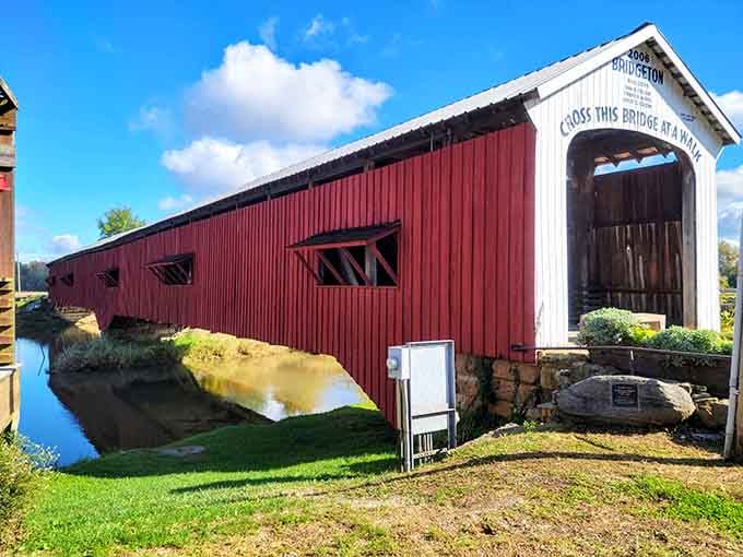 The crimson siding against blue sky and flowing creek proves Mother Nature knows her color theory perfectly.