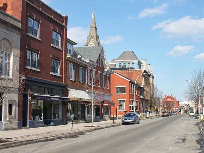 That church steeple rising above colorful storefronts proves small towns do architecture better than any strip mall ever could.