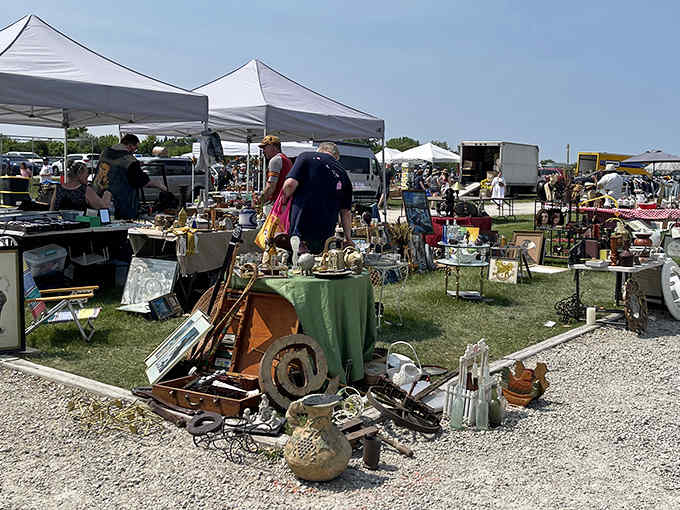 Sunshine streams across outdoor vendor stalls packed with rusty relics that tell stories from decades past.