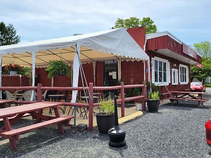 Red wooden benches and potted plants create the perfect casual setting for a satisfying meal with friends.