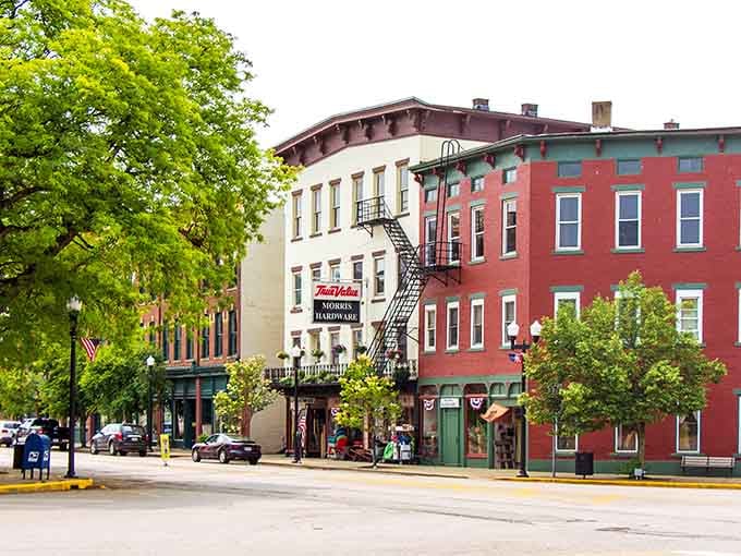 Colorful storefronts and leafy trees create a Main Street that looks straight out of a Norman Rockwell painting.