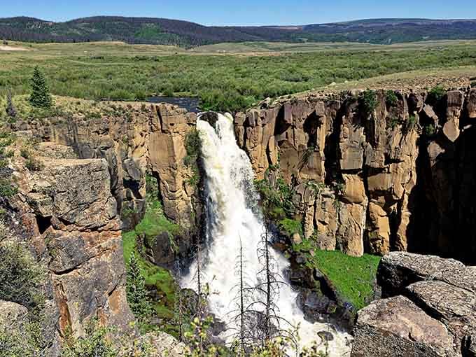 Those striped rock walls frame the waterfall perfectly, creating a scene that belongs on every bucket list.