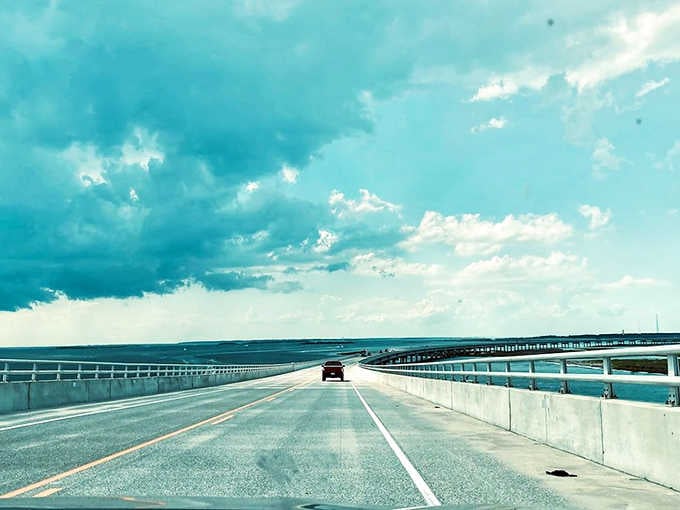 Driving over water with storm clouds gathering feels like starring in your own adventure movie scene.