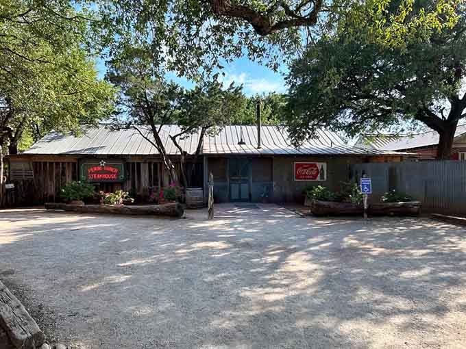 That weathered wood and tin roof hide some of the juiciest ribeyes you'll ever taste under these sprawling trees.