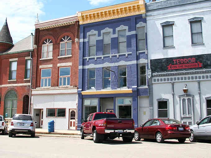 Each building wears a different color like Sunday best, creating a downtown palette more cheerful than any modern strip mall.