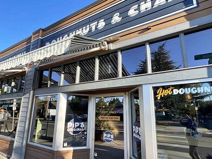 Sunlight catches those big windows perfectly, revealing the promise of fresh mini donuts and chai waiting inside.