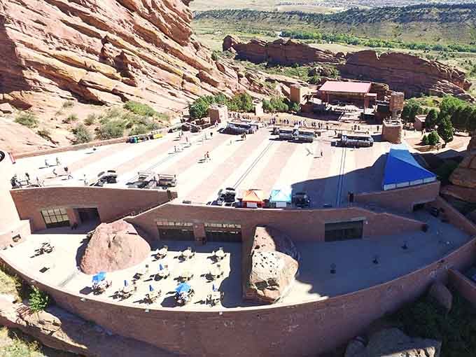 The backstage view reveals how these ancient red rocks cradle the amphitheatre like protective hands around a precious gem.