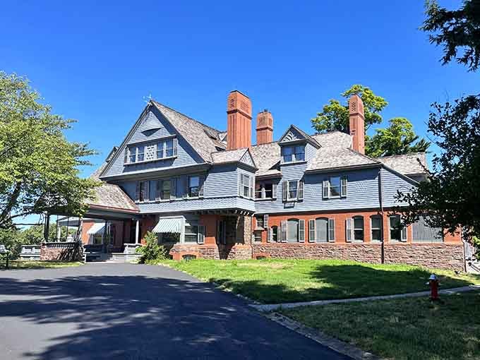 Those distinctive chimneys and wraparound porches whisper stories of a Rough Rider who loved coming home to this hill.