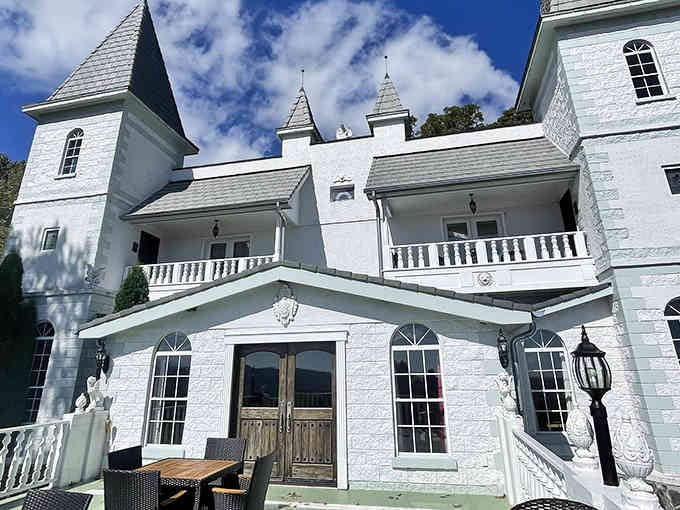 Blue skies meet pristine white turrets in this mountain castle that looks straight out of a storybook.