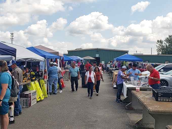 Shoppers stroll past colorful canopies under blue skies, hunting bargains like it's an Olympic sport they're determined to medal in.