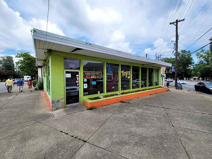 That lime green exterior practically glows with happiness, promising comfort food and outdoor seating under sunny skies.