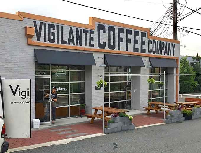 Those garage doors open up to reveal a modern coffee haven with a welcoming brick patio.