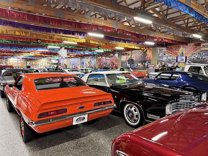 Chrome gleams under festive lights as muscle cars rest like jewels in a collector's dream garage.