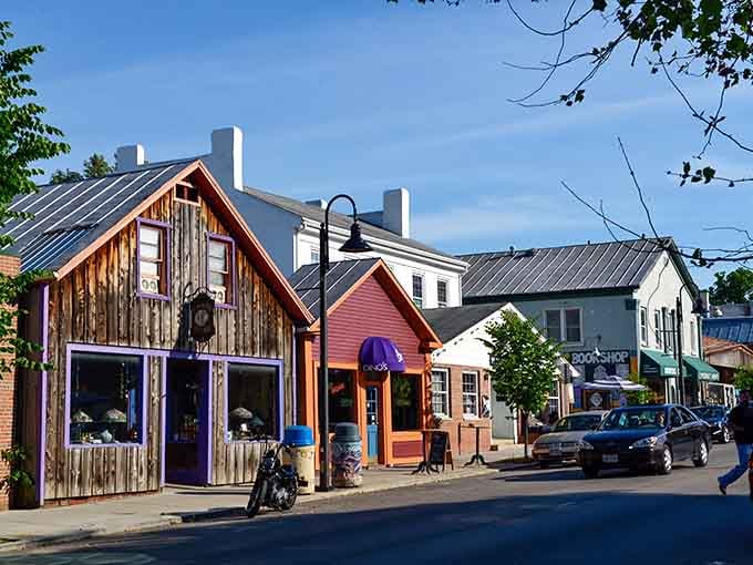 Wooden storefronts painted in cheerful colors line the street like a rainbow decided to open shop.
