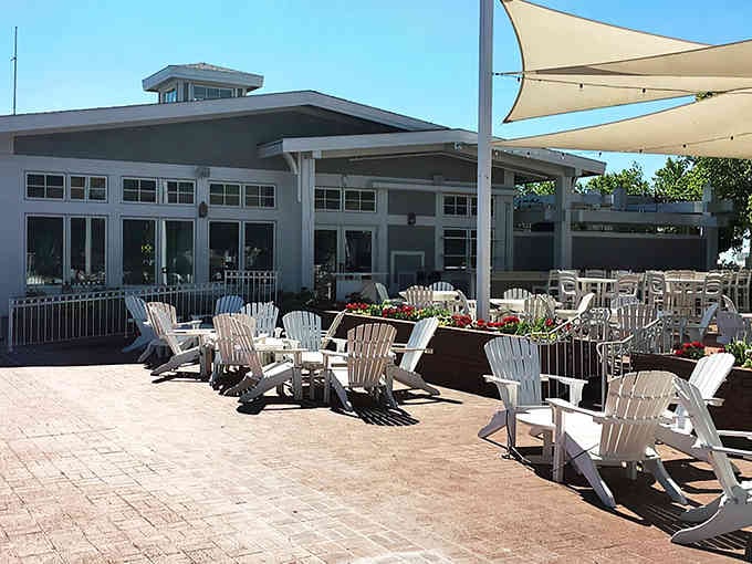 Those white Adirondack chairs are calling your name for post-meal relaxation with a lake view.