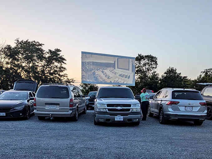 Cars lined up like eager theatergoers, each one a private box seat for tonight's double feature.