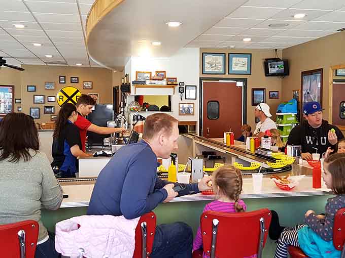 Counter seats offer front-row views of the train dispatch system, where miniature locomotives begin their delicious journeys.