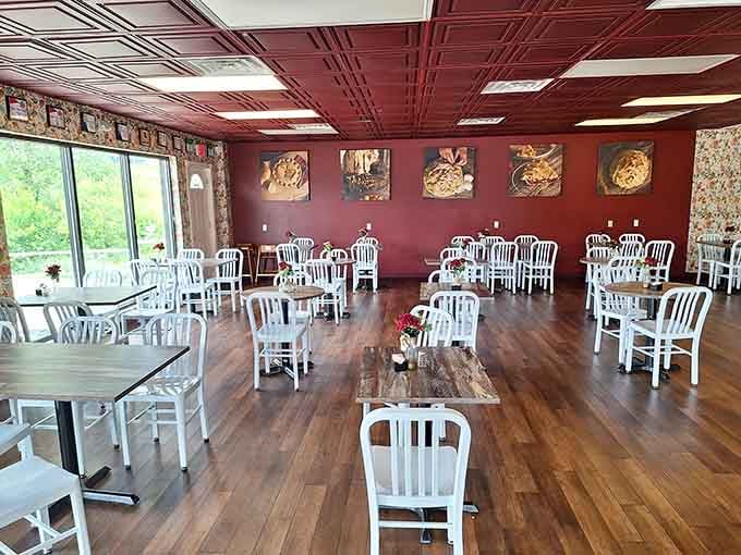 Burgundy walls and white chairs create a cozy dining room where pie dreams come true daily.
