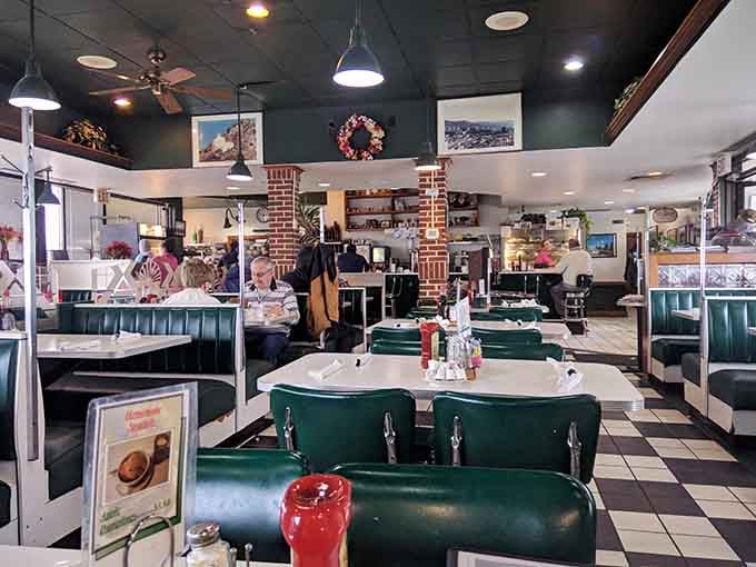 Green vinyl booths and checkered floors create the kind of timeless diner atmosphere that makes breakfast feel right.