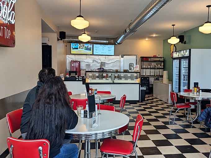 Classic diner vibes meet modern comfort in this retro paradise where checkered floors never go out of style.