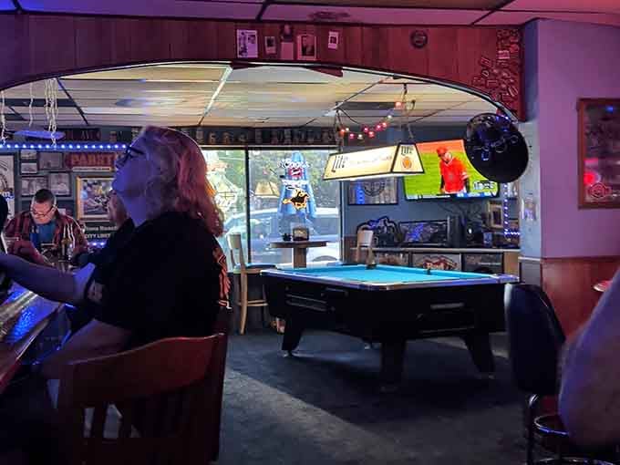 Pool table, Christmas lights, and a surfboard overhead? This is dive bar heaven done absolutely right.