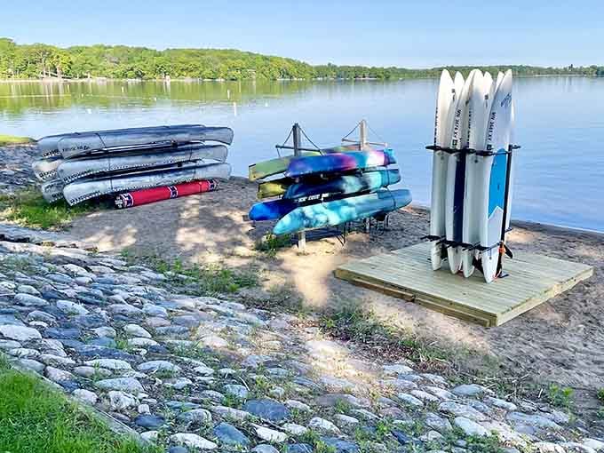 Kayaks and paddleboards lined up like colorful soldiers ready for aquatic duty on this pristine shoreline.
