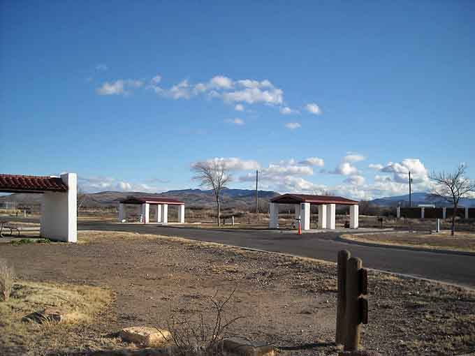 The classic park entrance stands ready to welcome visitors into a landscape where mountains meet endless sky beautifully.