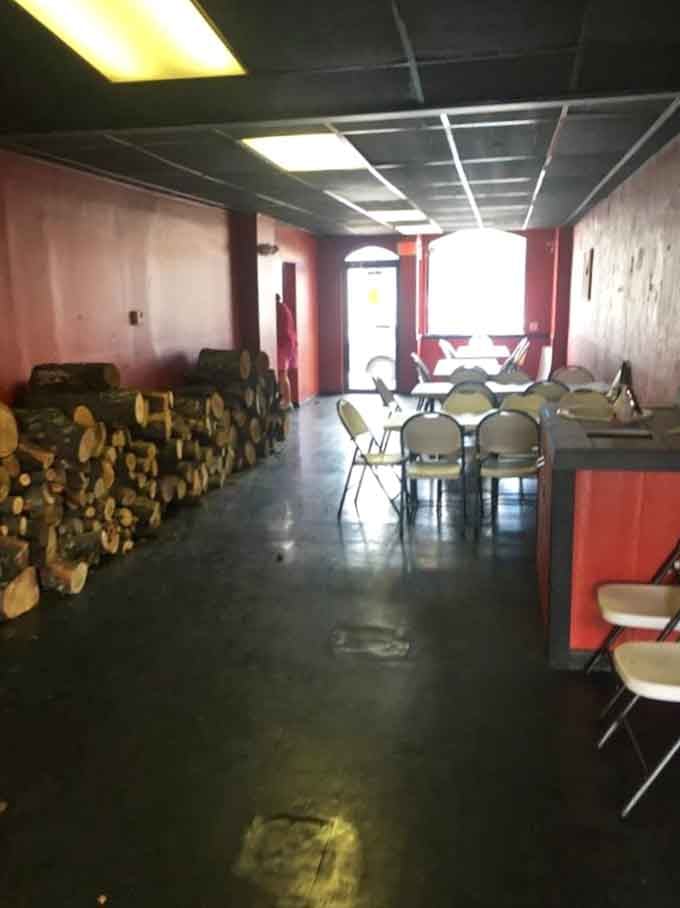Stacked firewood and simple seating mean serious business: they're focused on smoking perfection, not fancy decor.