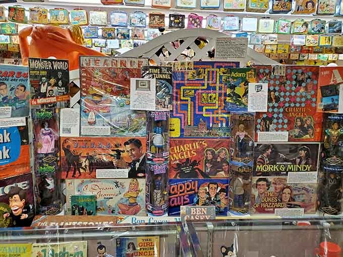 Vintage board games stacked like archaeological layers of childhood memories, each box a time capsule.