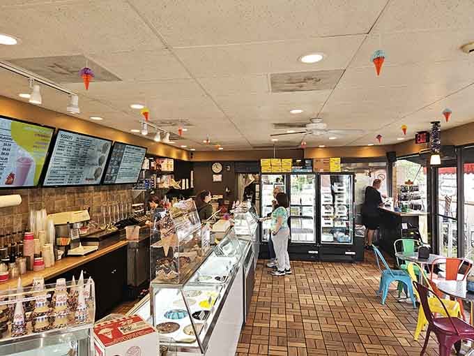 Colorful chairs and ice cream cone decorations create a playful atmosphere that makes choosing flavors even harder.