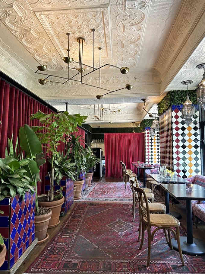 When your ceiling looks like it belongs in a European palace and your plants could hide a small orchestra, you're doing maximalism right.