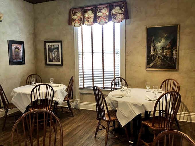White tablecloths and Windsor chairs create an atmosphere where elegance meets comfort in perfect harmony.