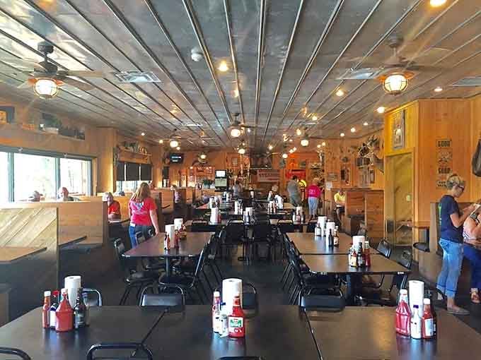 Wood paneling, metal ceiling, and tables ready for serious eating create the perfect no-nonsense steakhouse atmosphere.