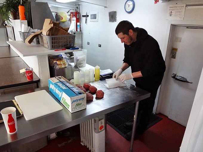 Behind that window, burger magic happens one fresh patty at a time on a spotless griddle ready for action.