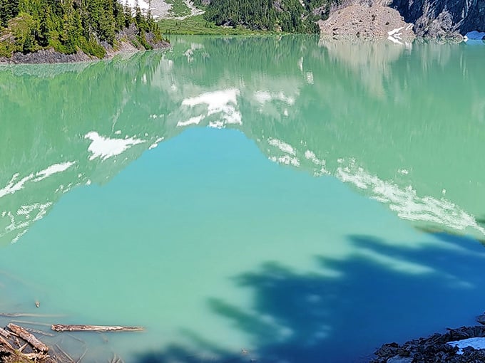 The water's reflection creates a mirror image so perfect, you'll question which way is up.