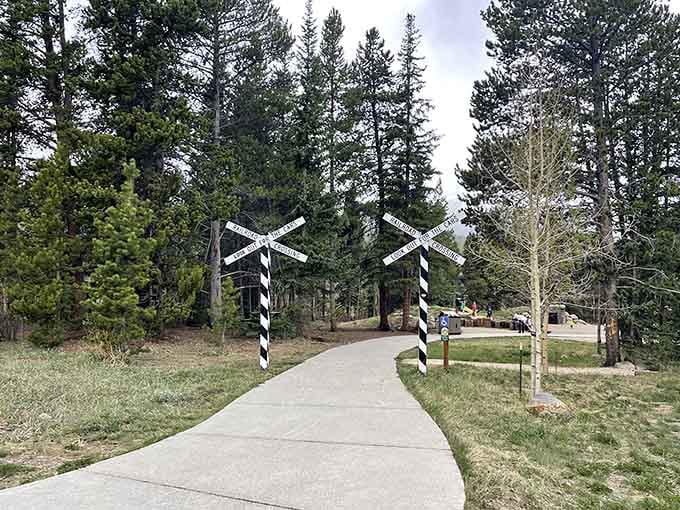 Railroad crossing signs mark your journey into history, where the only traffic jam involves nostalgia and wonder.