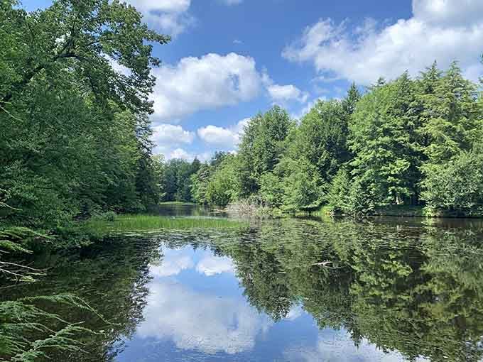 Water so still it doubles as nature's mirror, reflecting clouds that look better than any screensaver ever could.