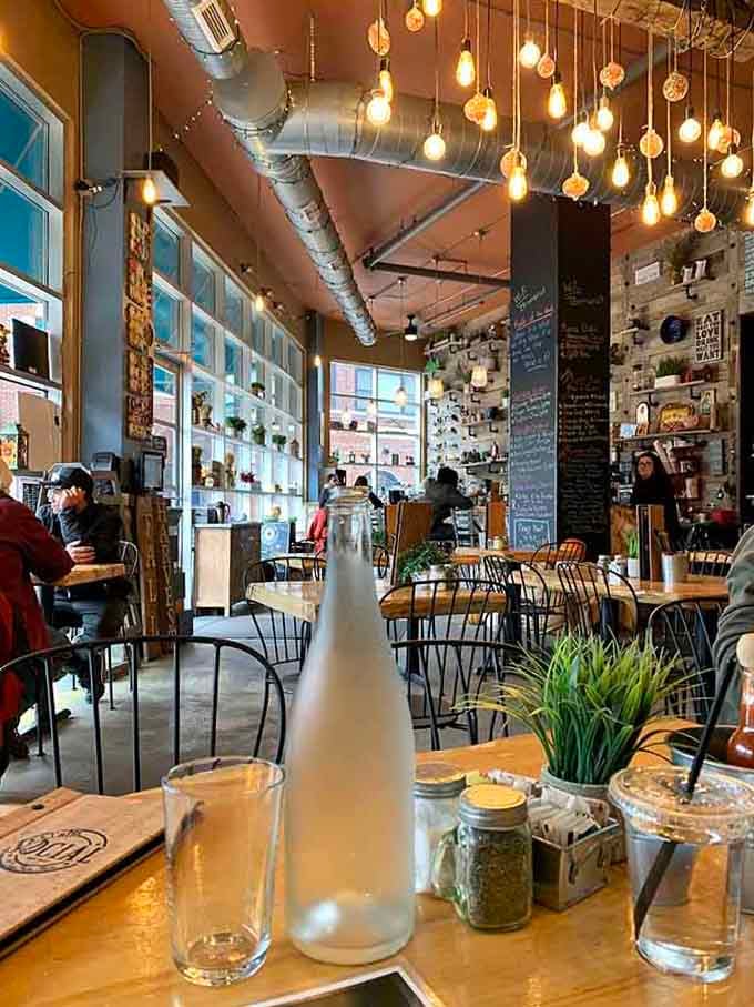Industrial chic meets cozy cafe vibes, where Edison bulbs dangle overhead like delicious little promises of caffeinated joy.
