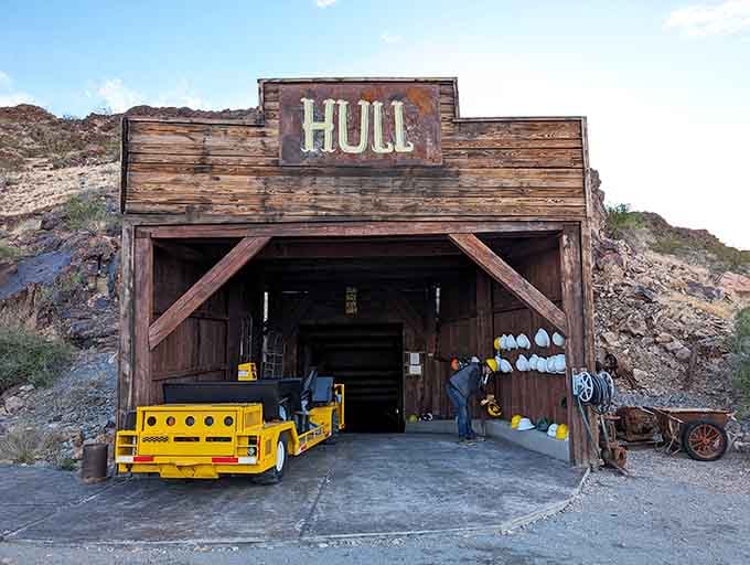 The Hull Mine entrance beckons with vintage equipment standing guard, ready to transport you into Arizona's glittering past.