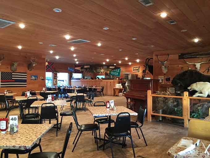 Wood paneling, mounted trophies, and tables ready for feasting create the ultimate supper club atmosphere.