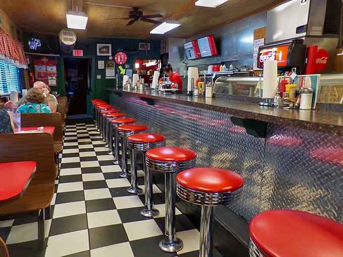 Classic diner counter with spinning stools&mdash;where strangers become friends over coffee and countless refills await.