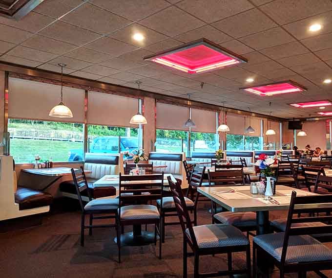 Pink-lit booths and big windows create that perfect diner atmosphere where good food meets great conversation naturally.