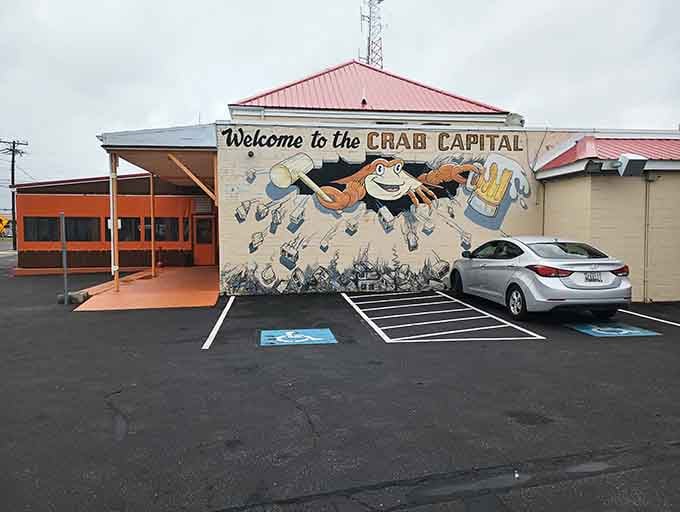 That cheerful crab holding a beer knows exactly what kind of town this is, pure Chesapeake Bay joy.